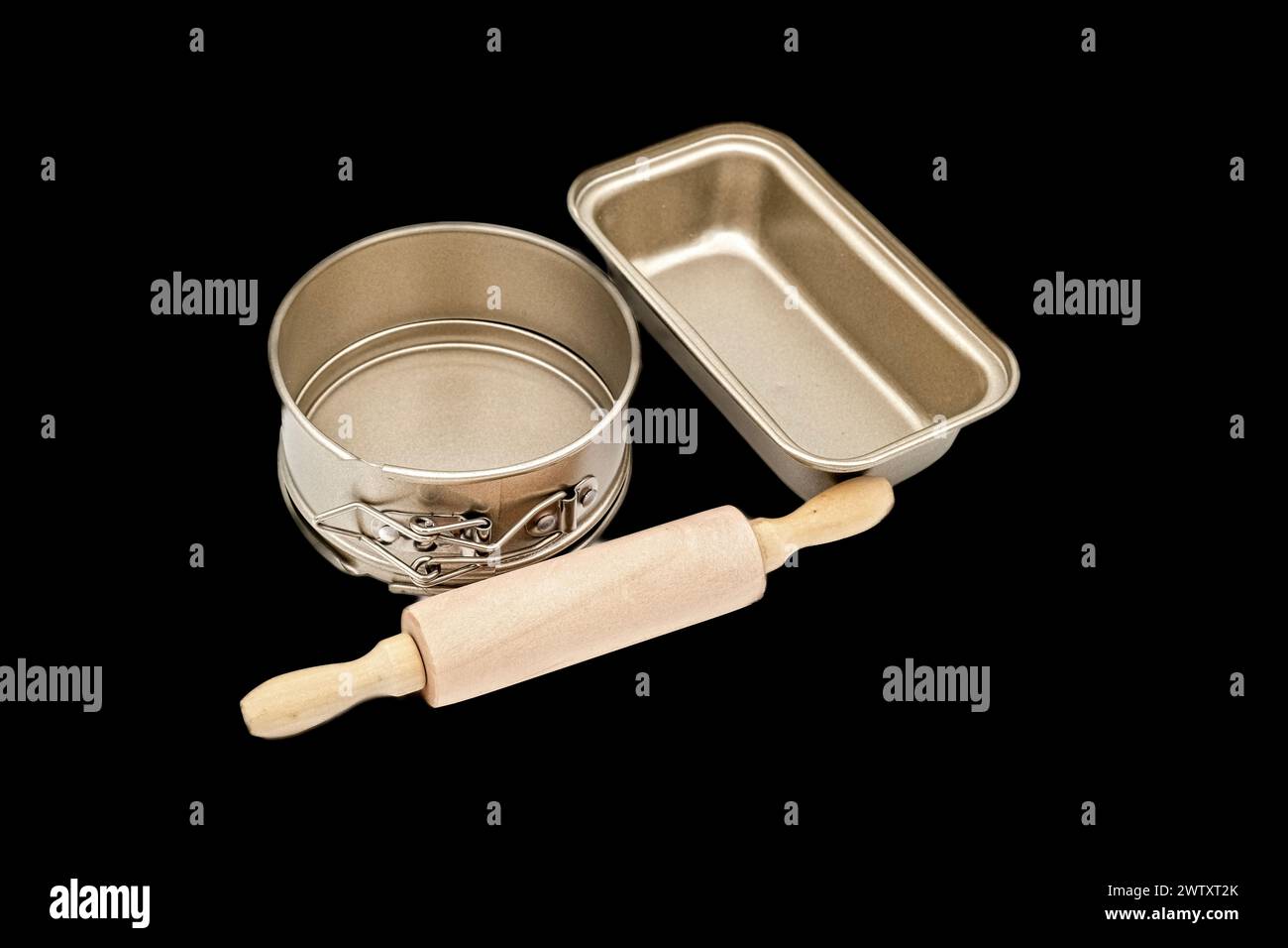 Baking forms for cake with Wooden rolling pin on black background Stock ...