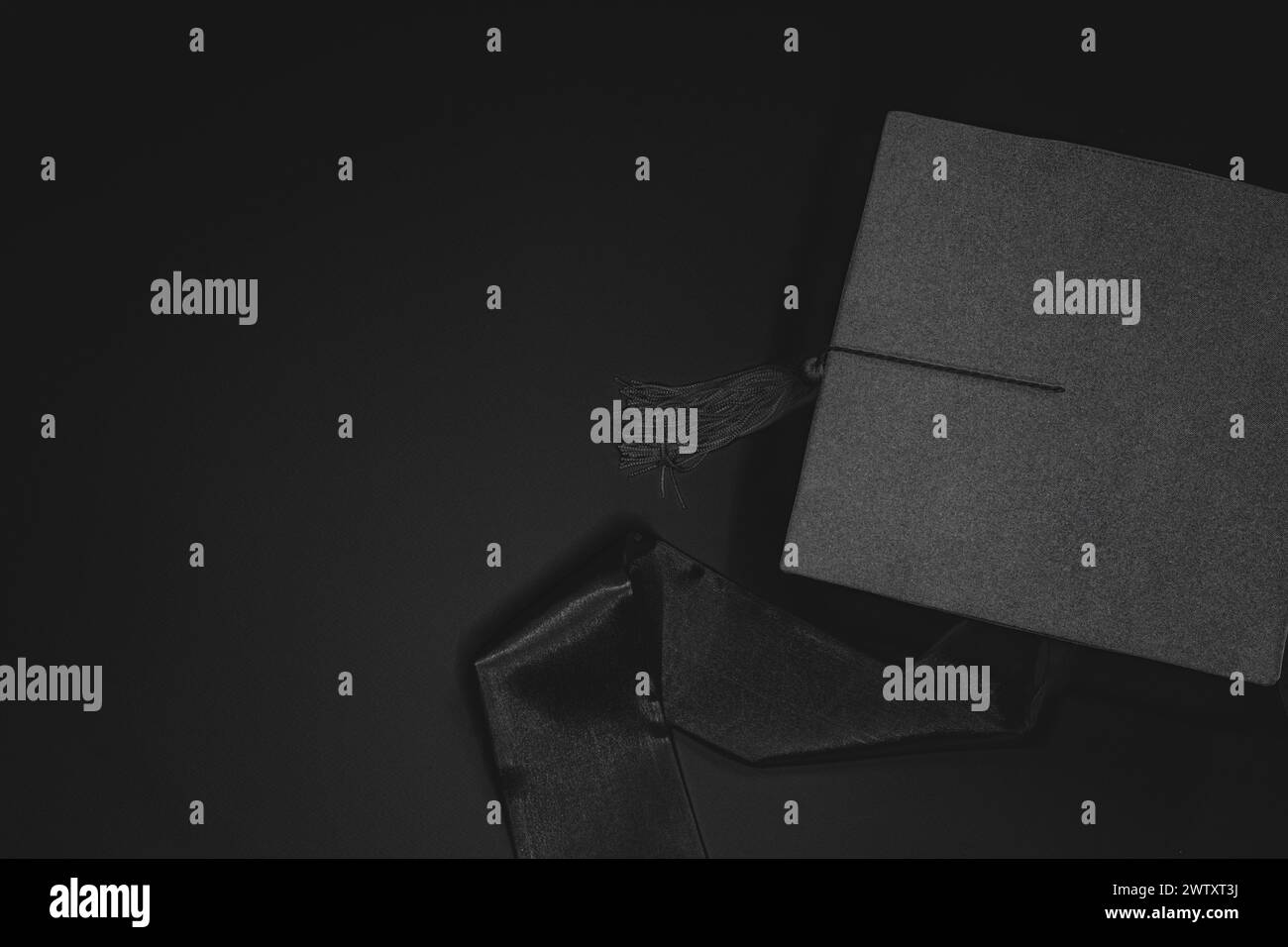 Graduation cap on dark grey background Stock Photo - Alamy