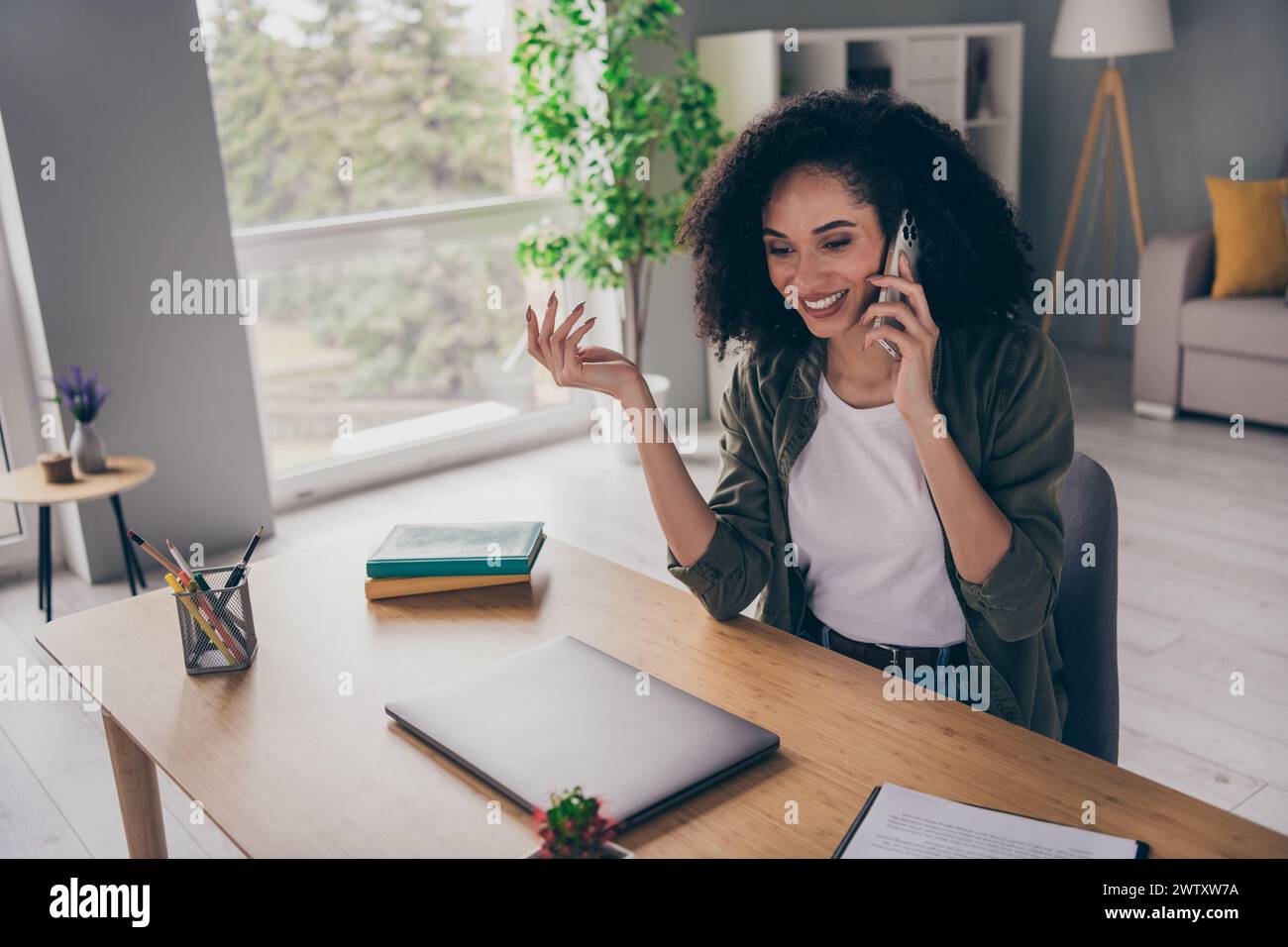 Photo of impressed happy lady freelancer dressed shirt answering call ...