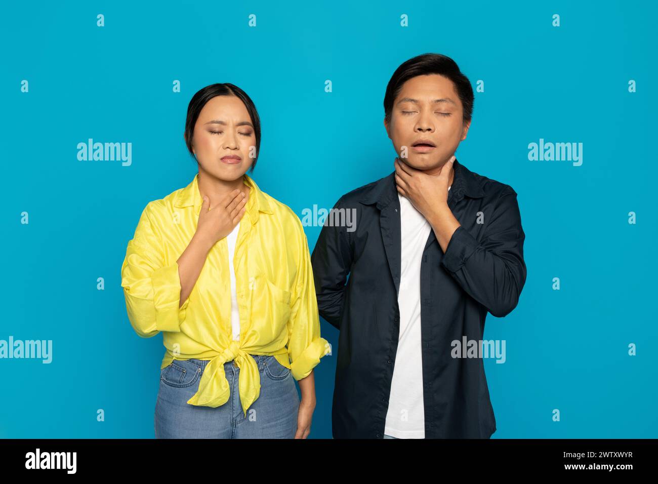 A woman and a man in vibrant attire appear distressed, with the woman ...