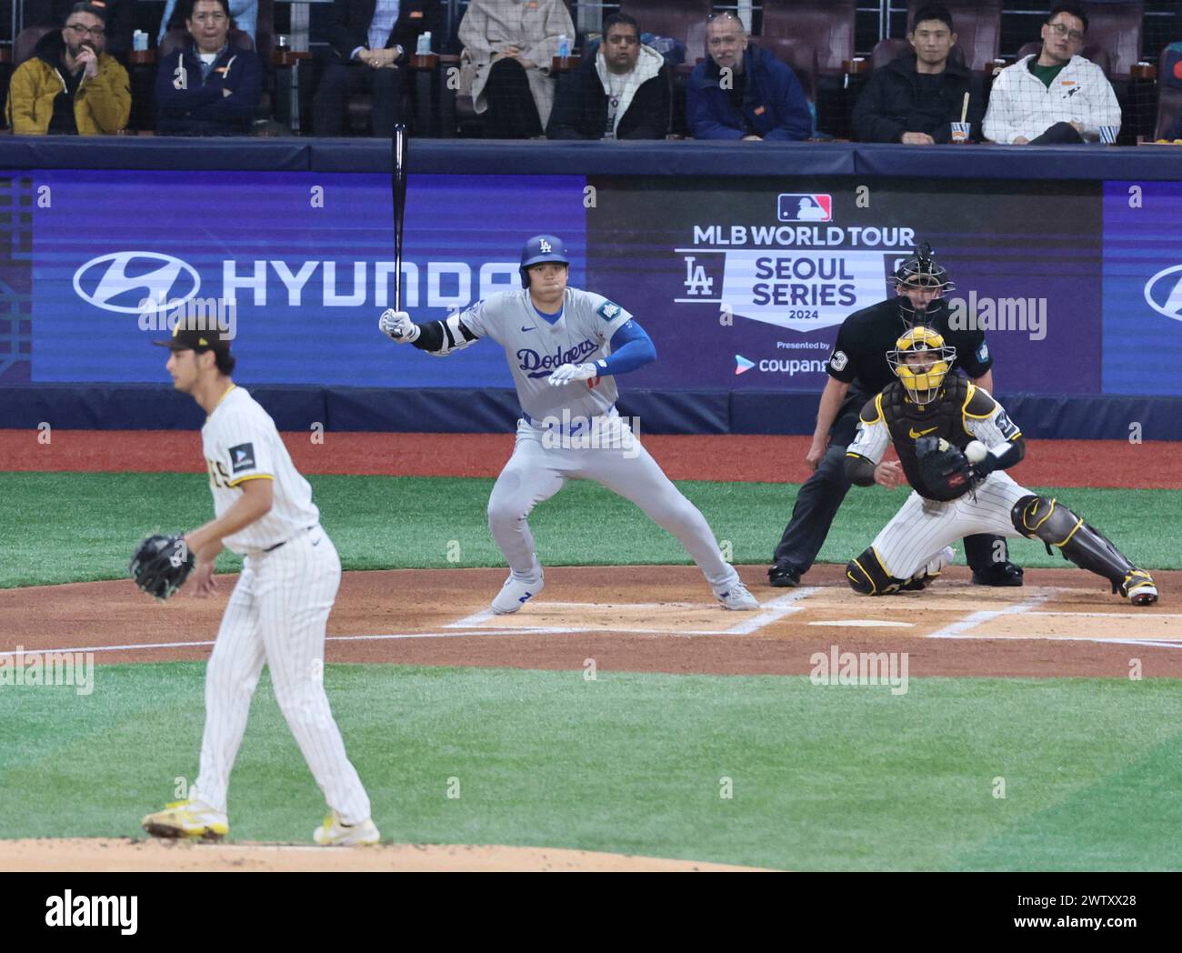Shohei Ohtani (backround) of the Los Angeles Dodgers hits an infield ...