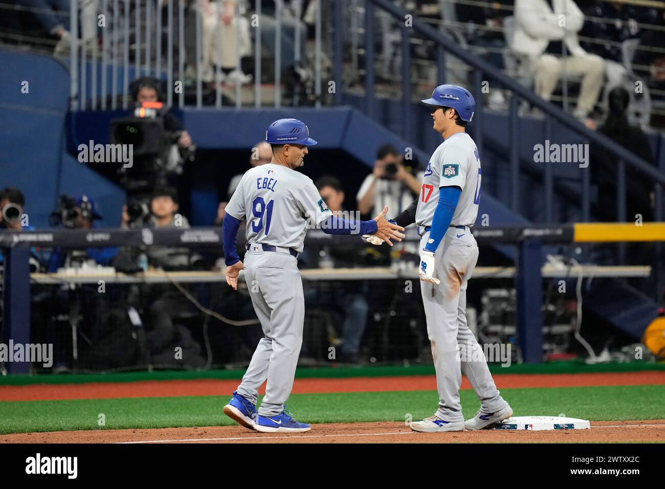 Los Angeles Dodgers third base coach Dino Ebel, left, shakes hand with ...
