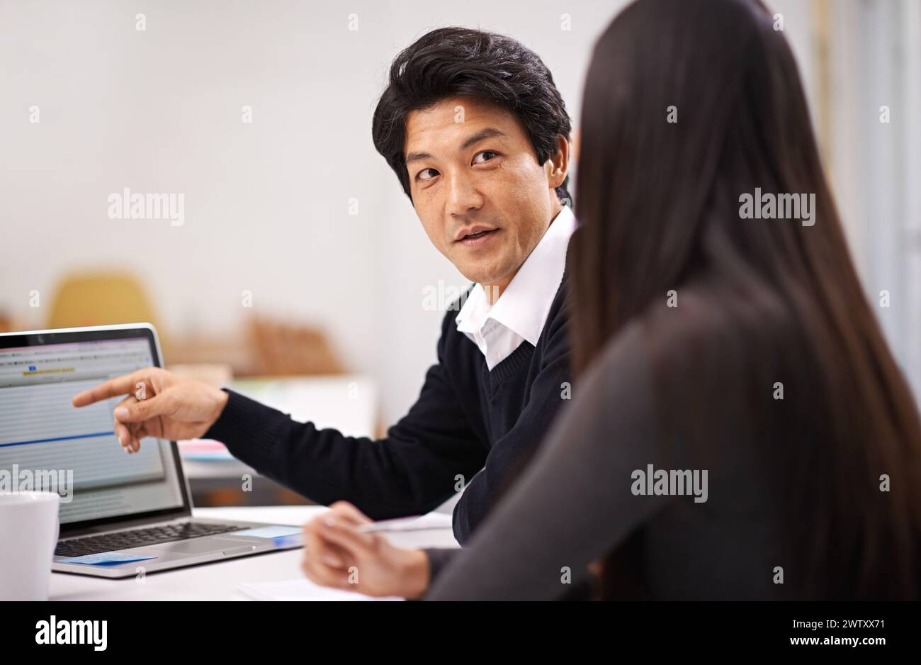 People, help and learning to work with laptop in Japanese business with ...