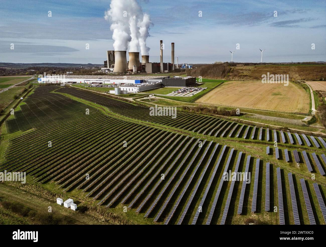 Eschweiler, Germany. 21st Mar, 2024. A field with solar panels lies in ...
