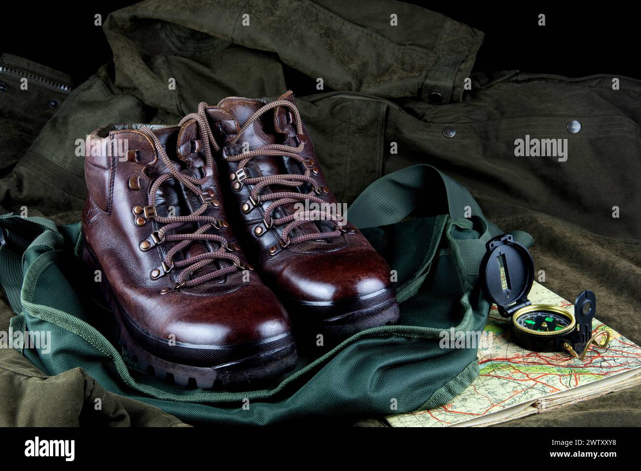 Old hiking boots with old map and compass on a game bag and outdoor ...