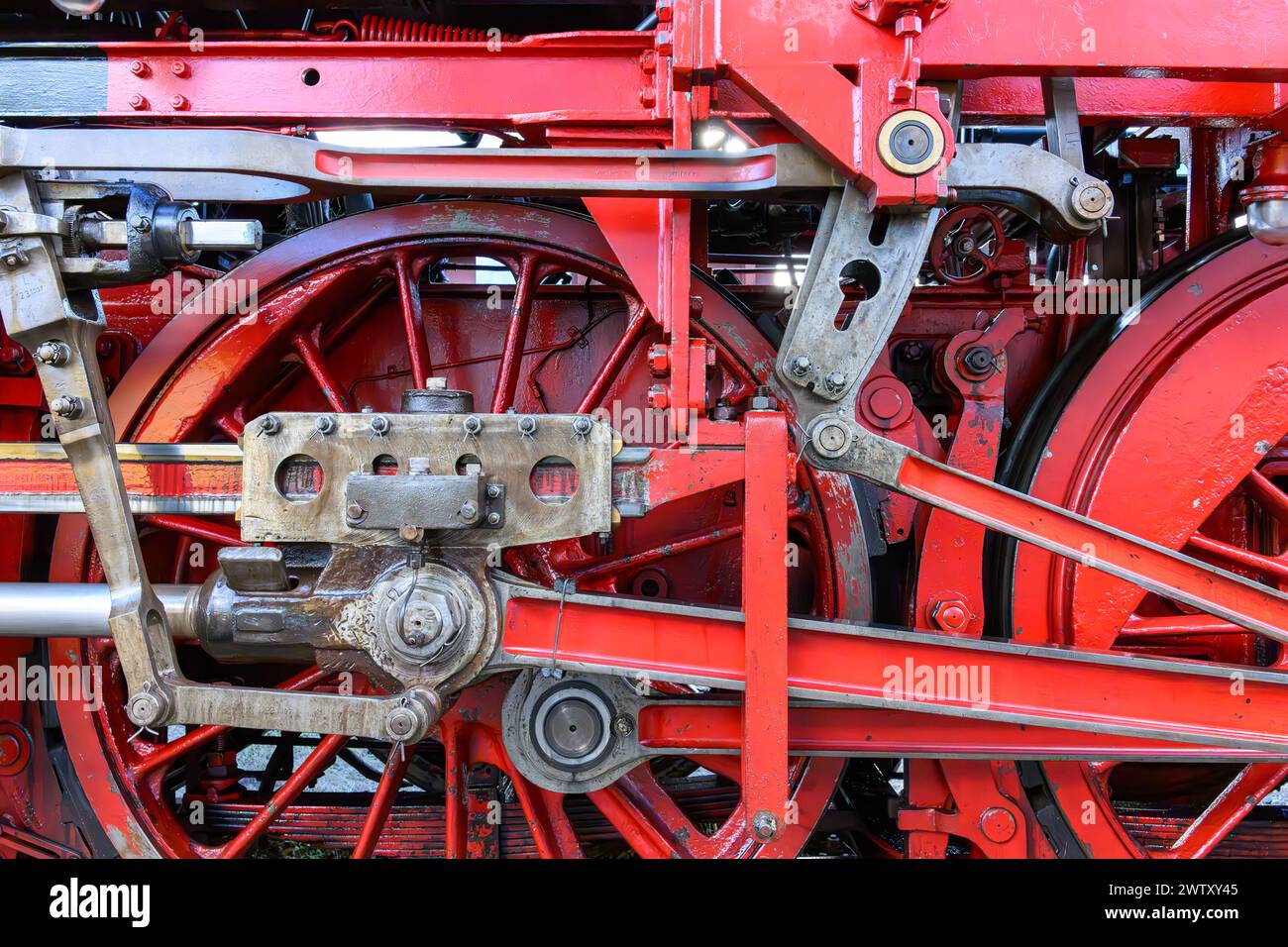 Two red wheels of an old steam locomotive with drive linkage Stock ...