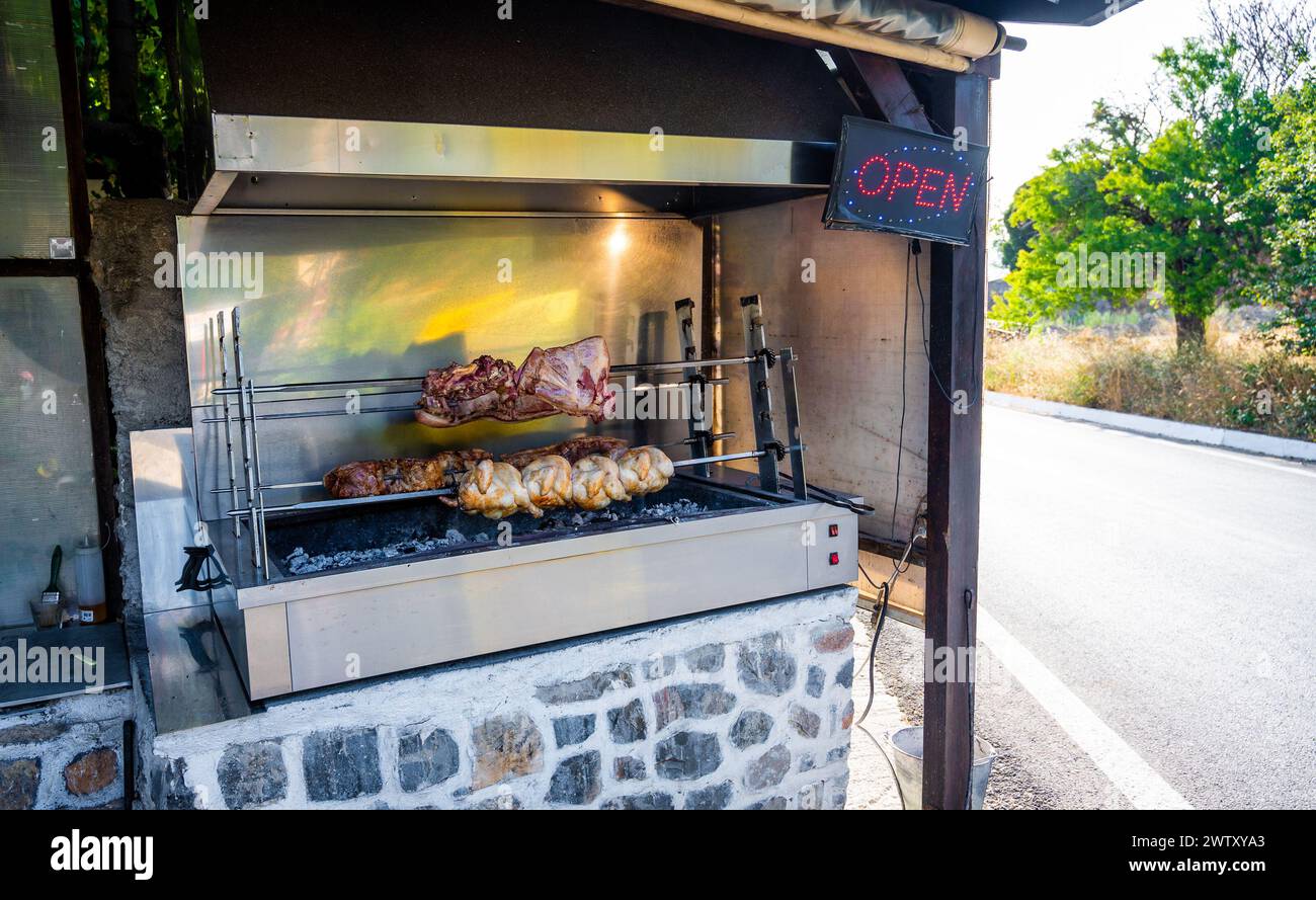 Roadside restaurants spit grill skewers barbecue in Crete, Greece. BBQ ...