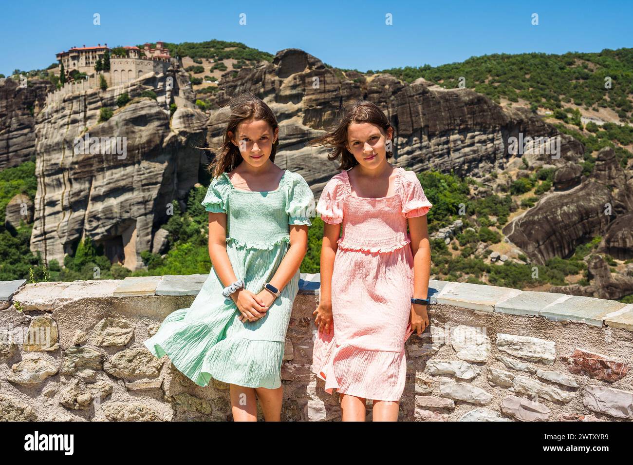 Portrait of children visiting the famous Meteora monastery in Greece ...