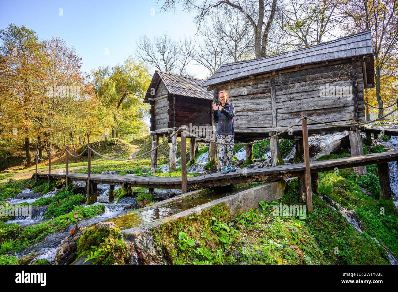 Tourist woman visiting old small wooden water mills called Mlincici ...