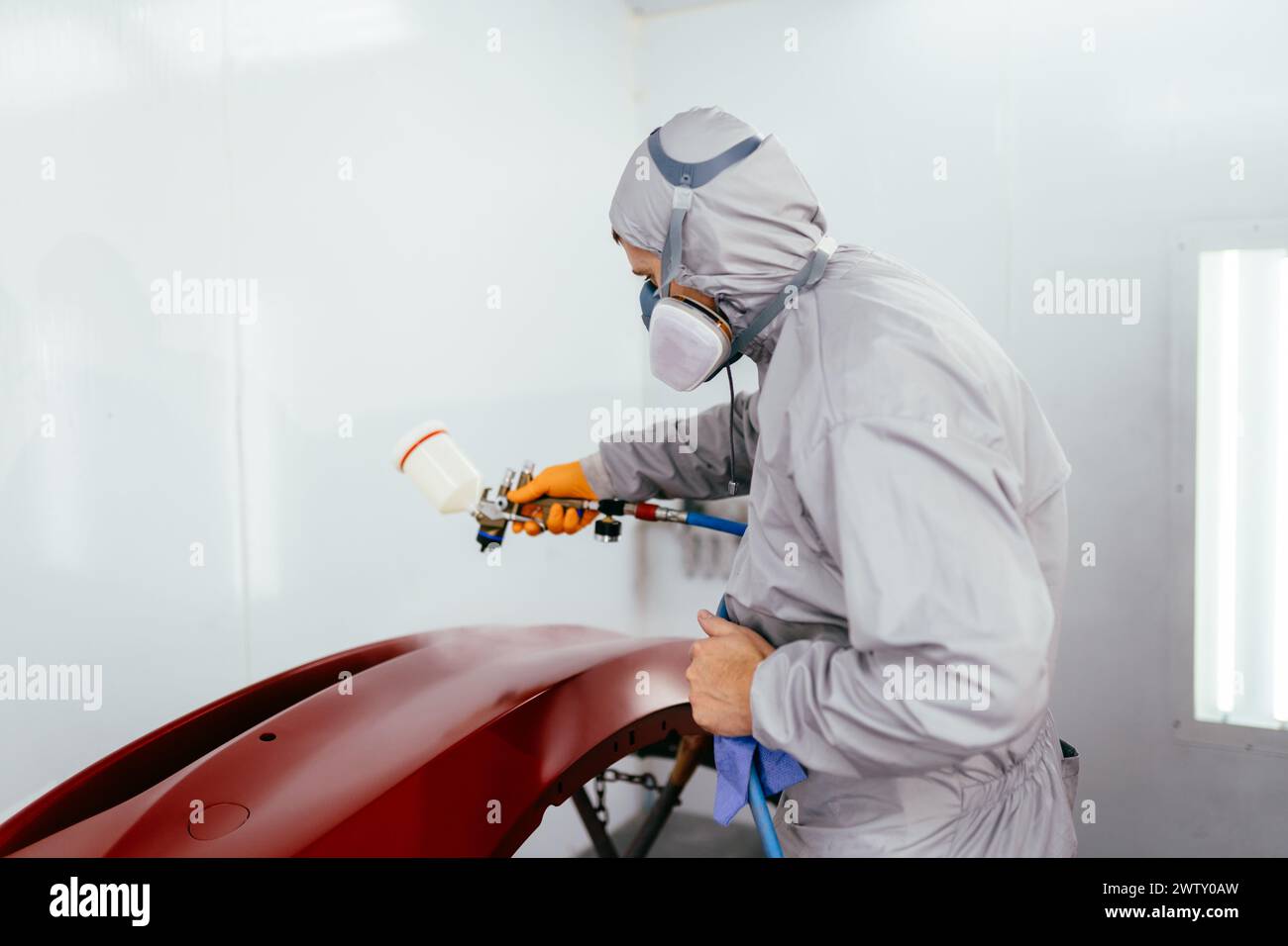 Car painter repairman painter in chamber painting automobile car bumper ...