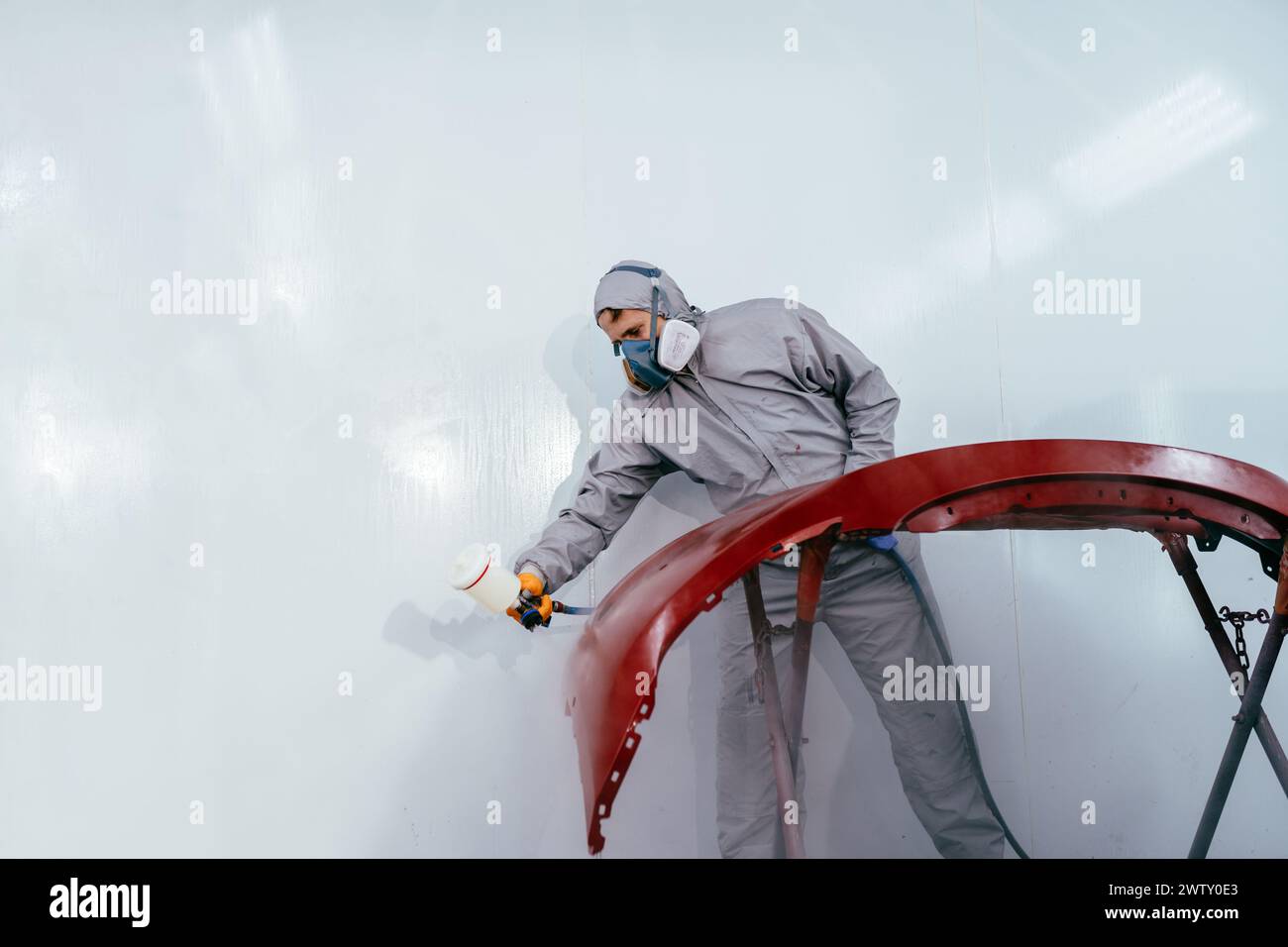 Car painter repairman painter in chamber painting automobile car bumper ...