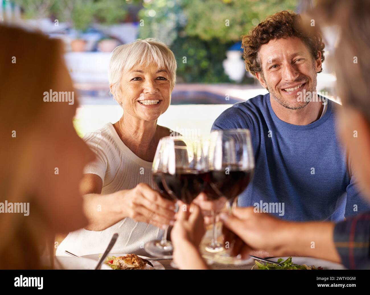 Family, lunch and cheers with smile, celebration and bonding together ...