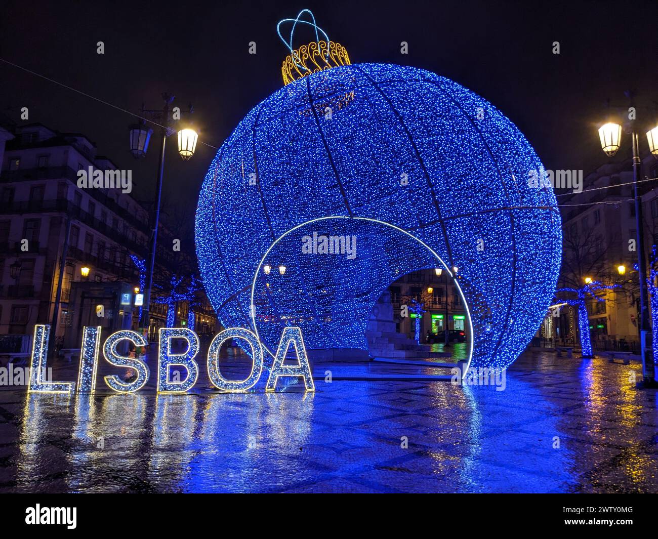 Illuminated sphere stands before city structures Stock Photo - Alamy