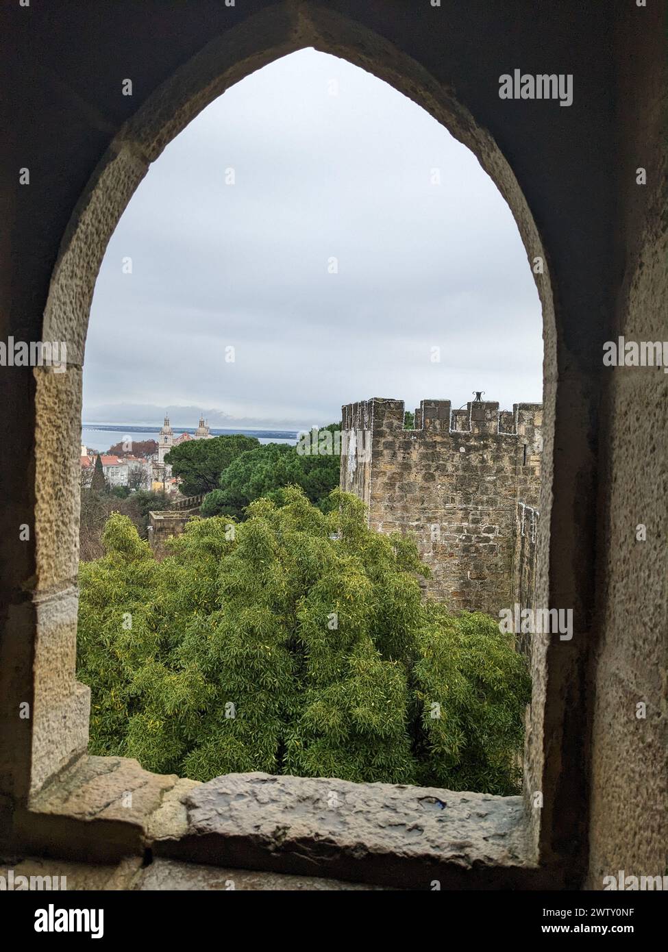 Ancient arch overlooking castle wall and distant island Stock Photo - Alamy