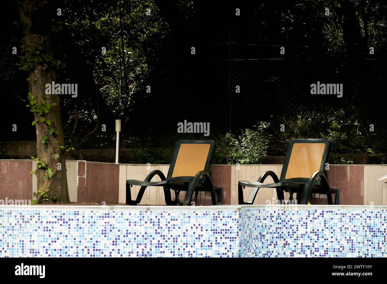 Side view of black and brown plastic sun loungers for relaxing on the ...