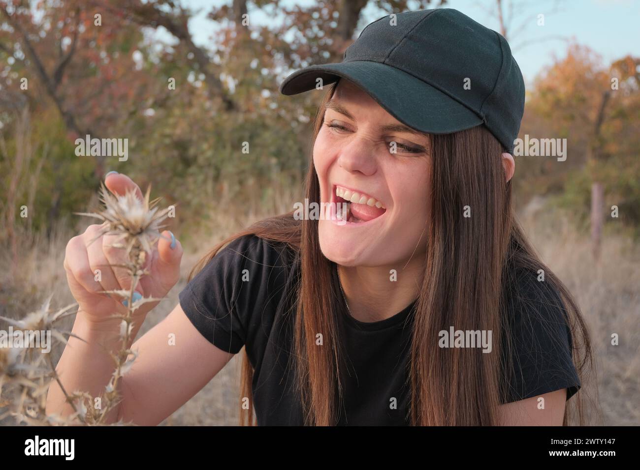 Emotional reaction of a young woman to a prickly plant hi-res stock photography and images - Alamy