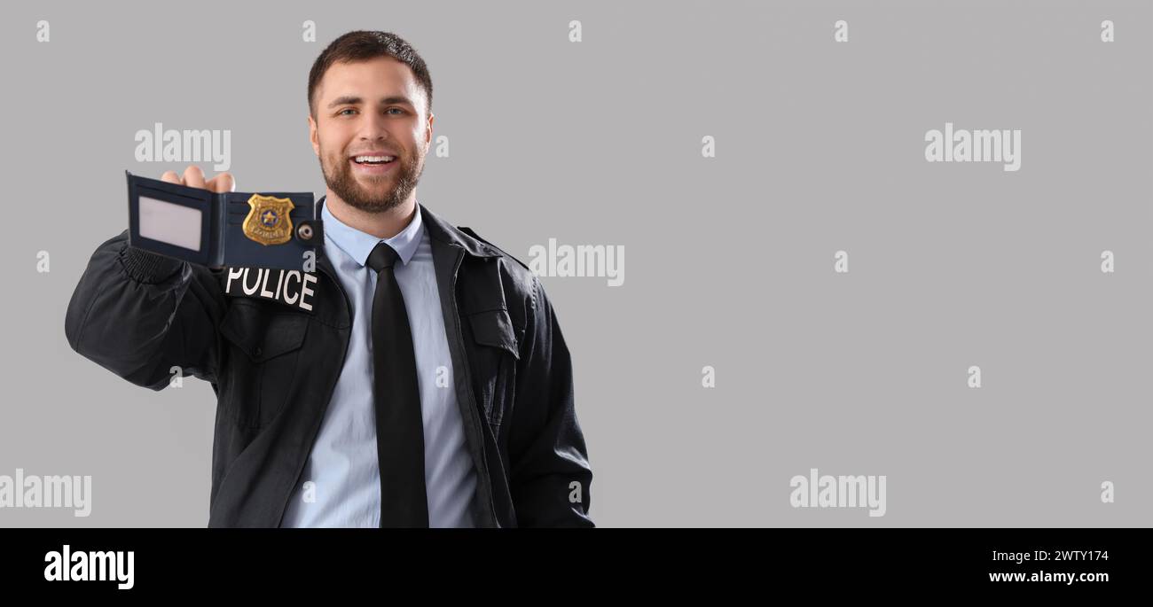 Male police officer showing documents on light background with space ...