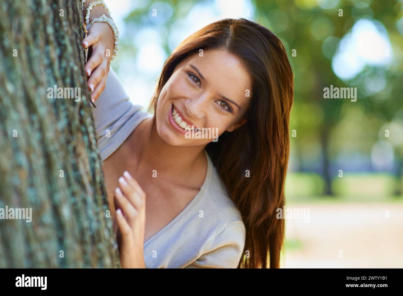 Woman, enviroment and tree with smile, portrait and happiness with joy ...
