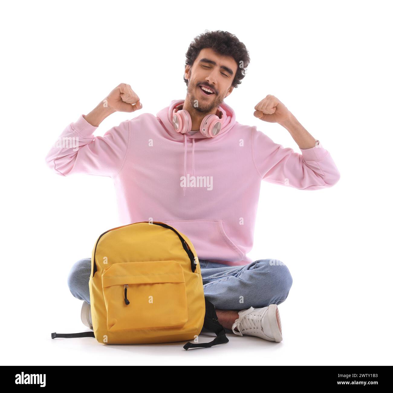 Male student with backpack sitting on white background Stock Photo - Alamy