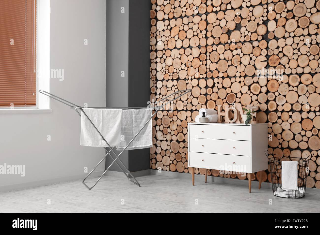 Interior of room with laundry basket, commode and dryer Stock Photo - Alamy