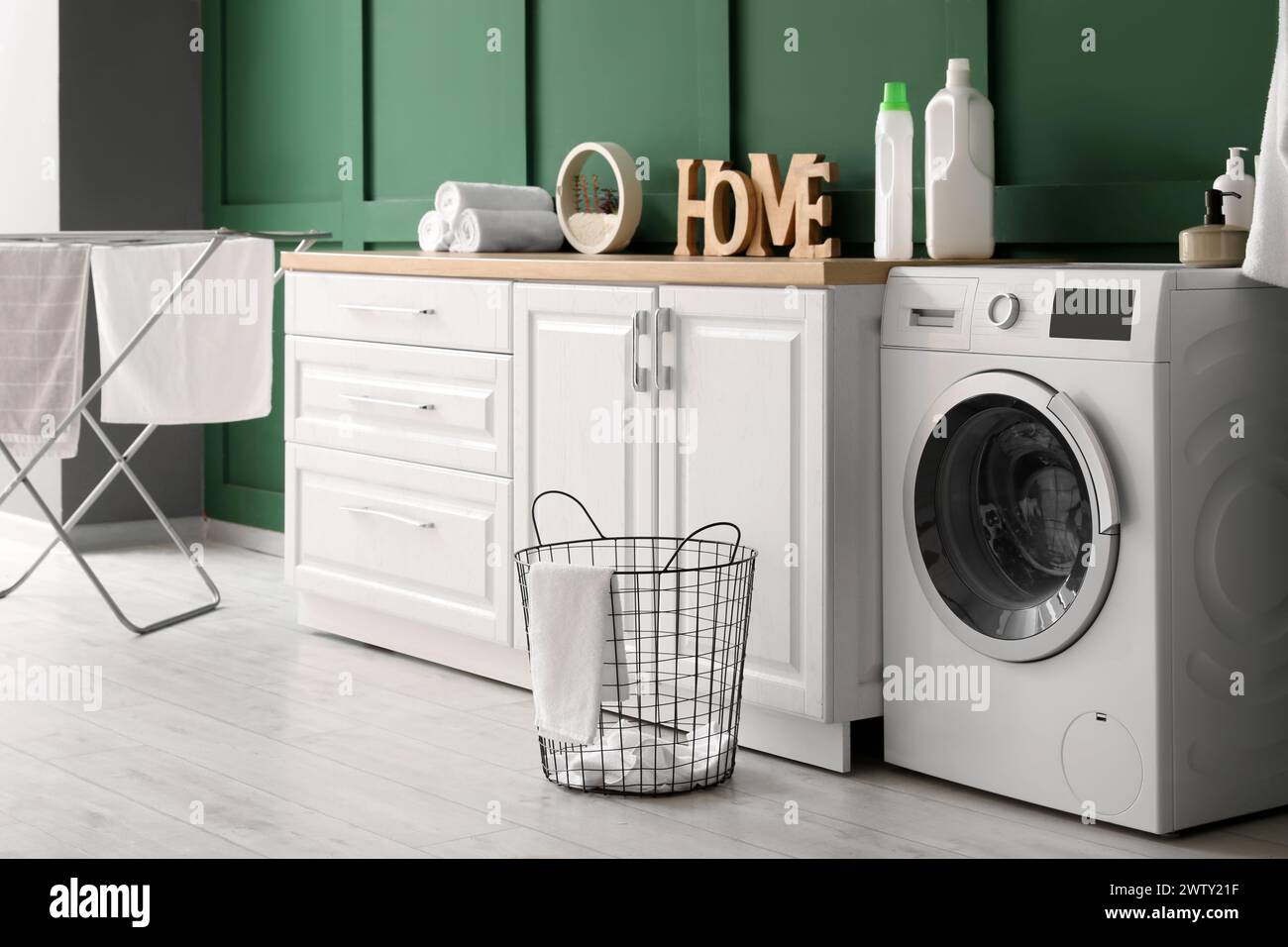 Interior of room with laundry basket, washing machine and counters ...