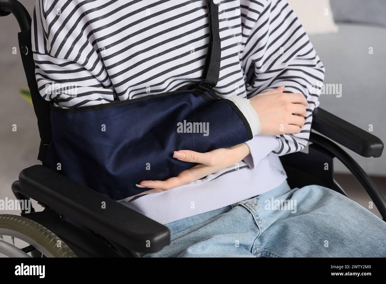 Injured young woman with broken arm in wheelchair after accident at ...