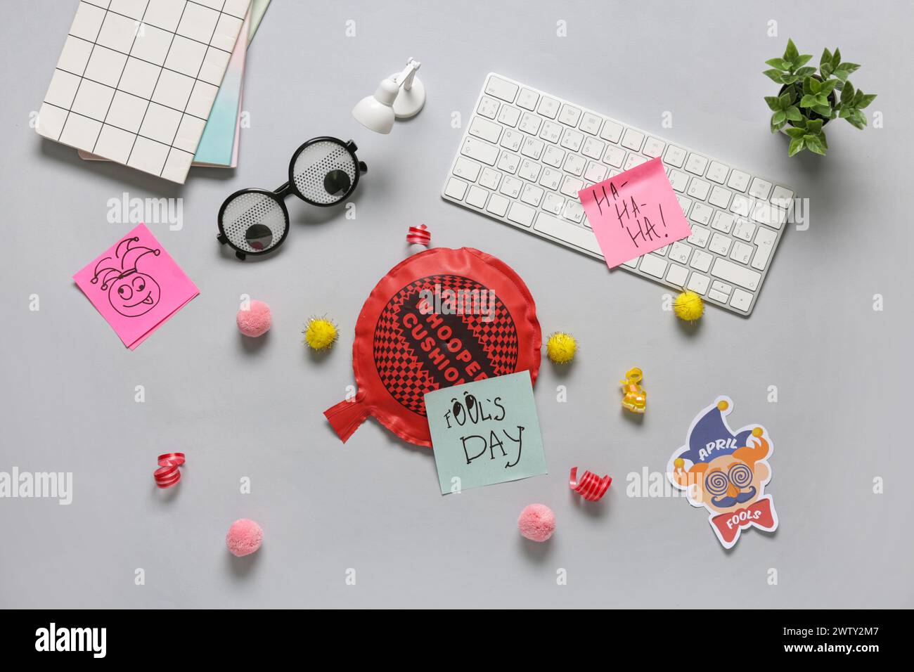 Computer keyboard with whoopee cushion, funny glasses and sticky notes ...