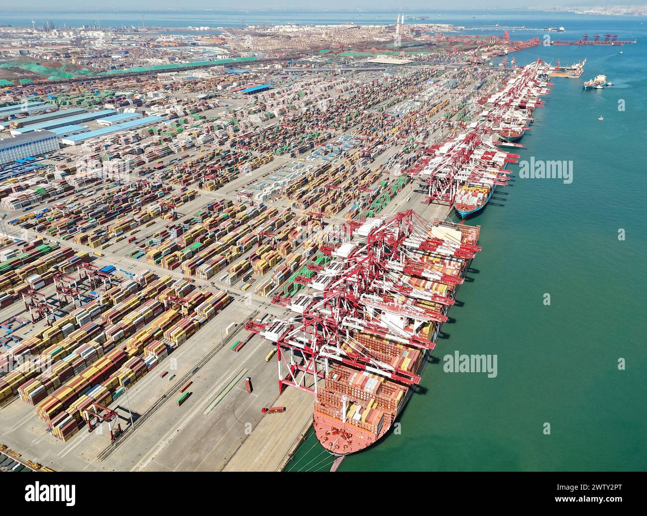 QINGDAO, CHINA - MARCH 20, 2024 - Dozens of freighters load and unload ...