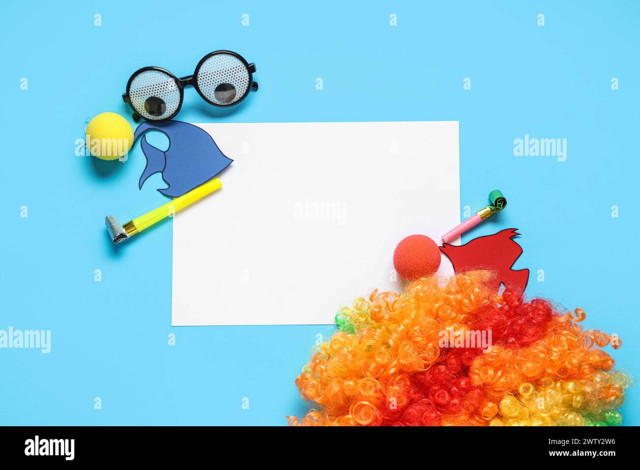 Blank card with paper fishes, clown wig and funny glasses on blue ...