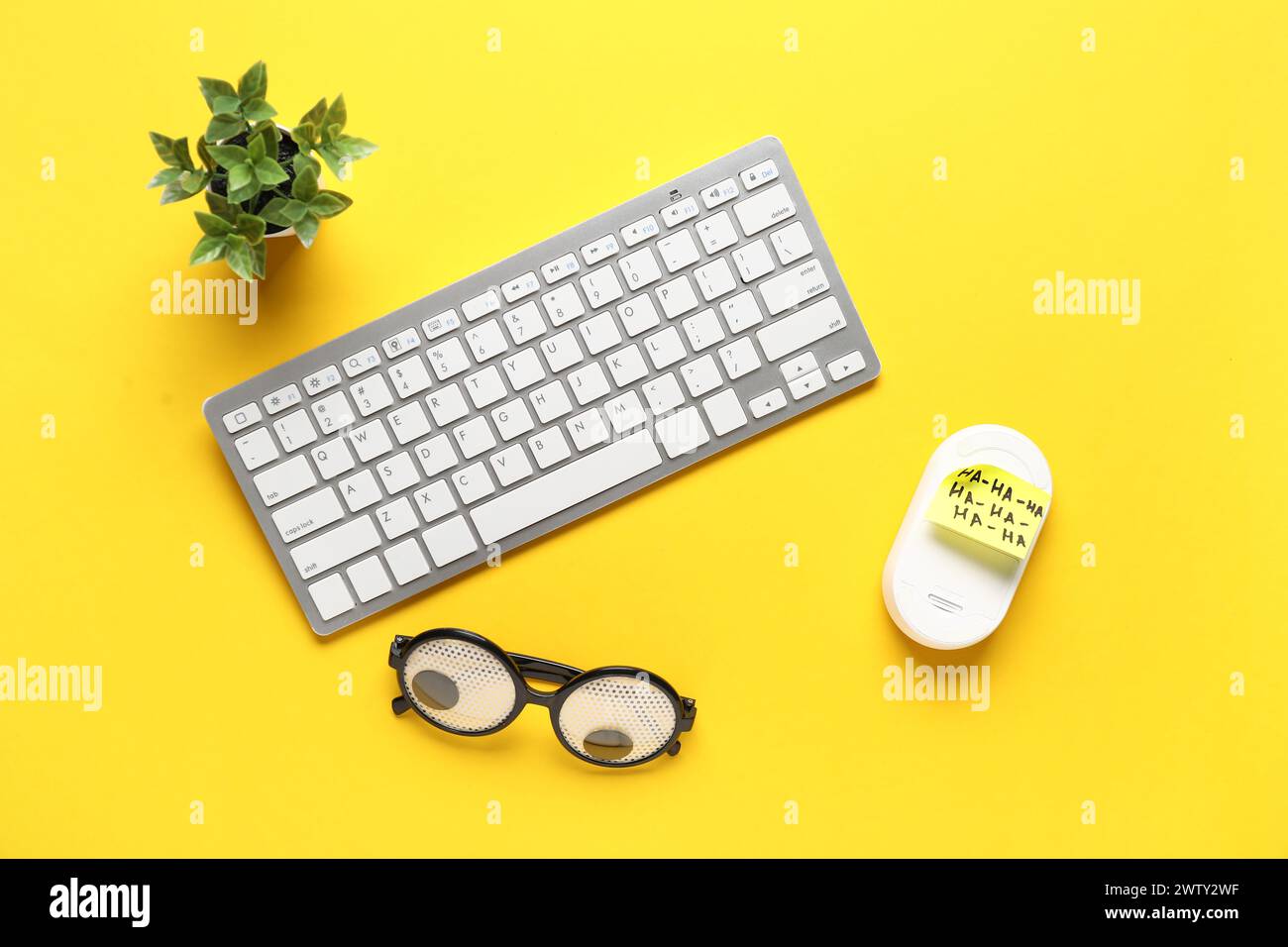 Funny glasses, sticky note, computer keyboard and mouse on yellow ...