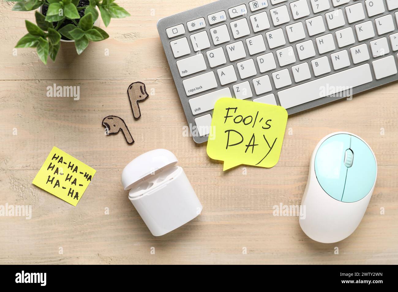 Carton earphones, sticky notes and computer keyboard on wooden ...