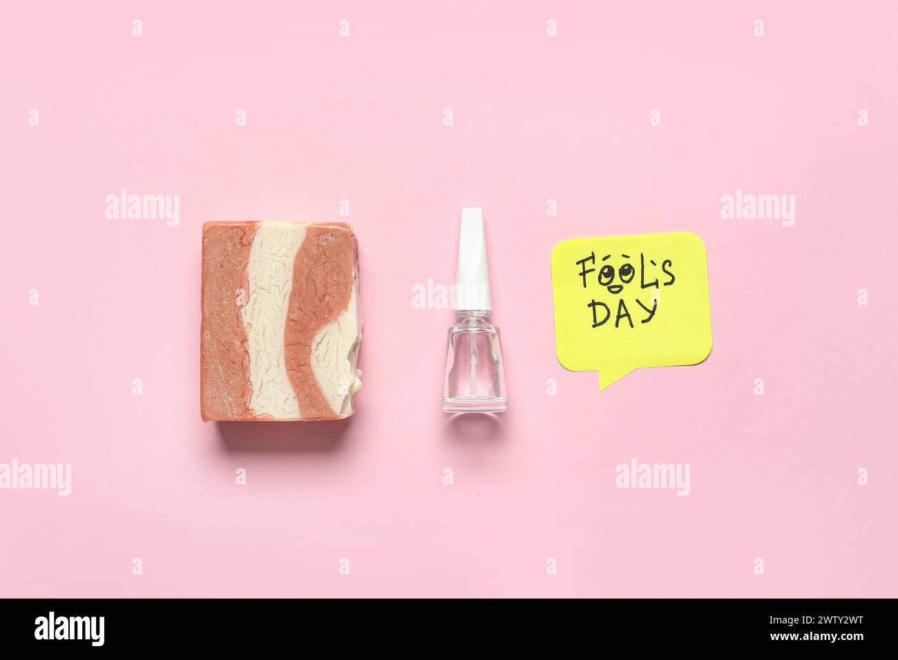 Nail polish, soap and sticky note on pink background. April Fools Day ...
