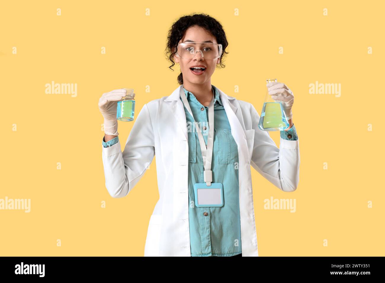 Female African-American chemist with flasks on yellow background Stock ...