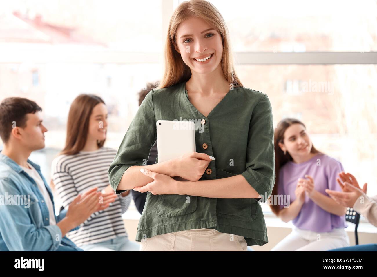 Female psychologist with tablet computer at group therapy session Stock ...
