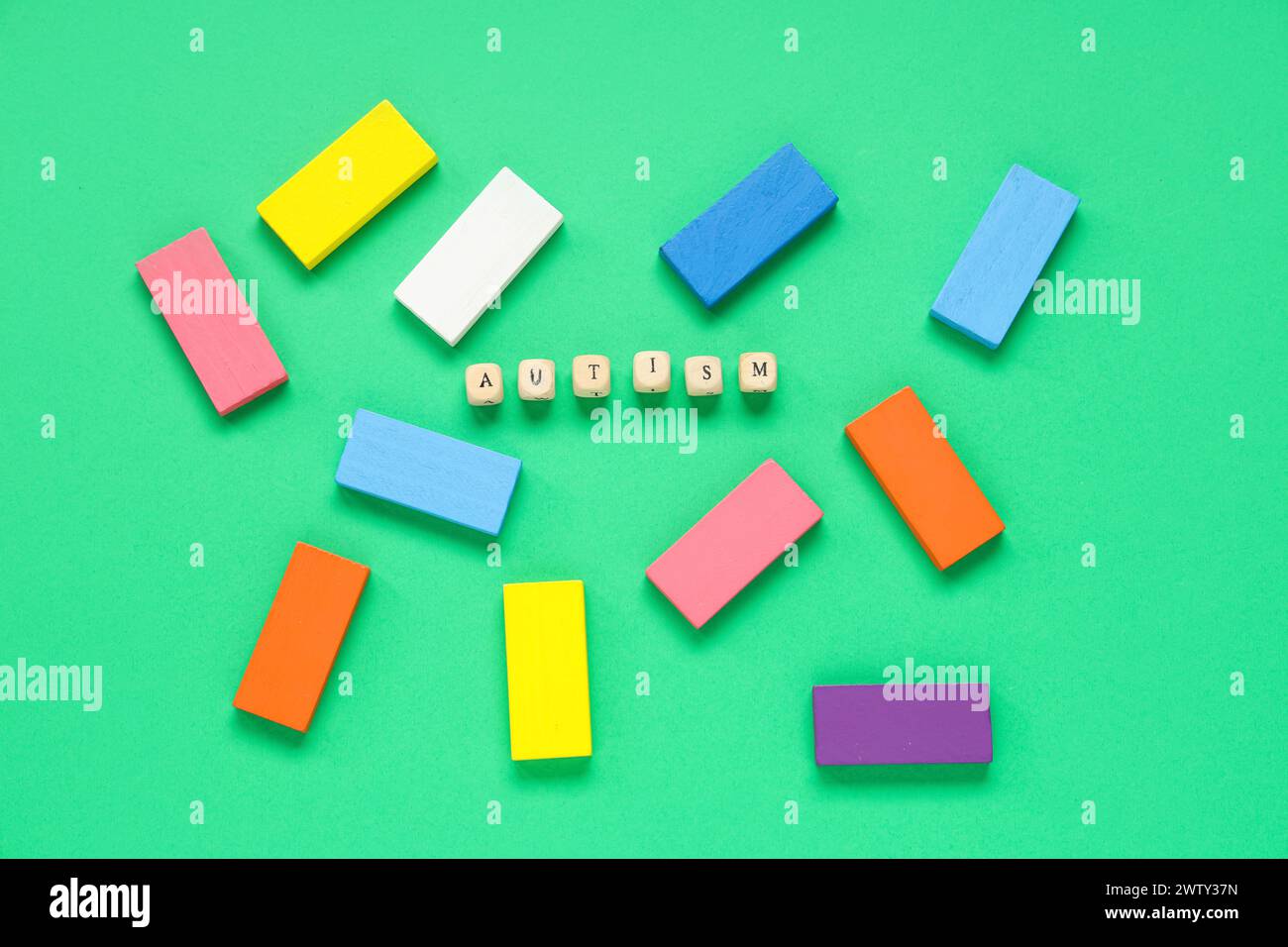 Word AUTISM and colorful blocks on green background Stock Photo - Alamy