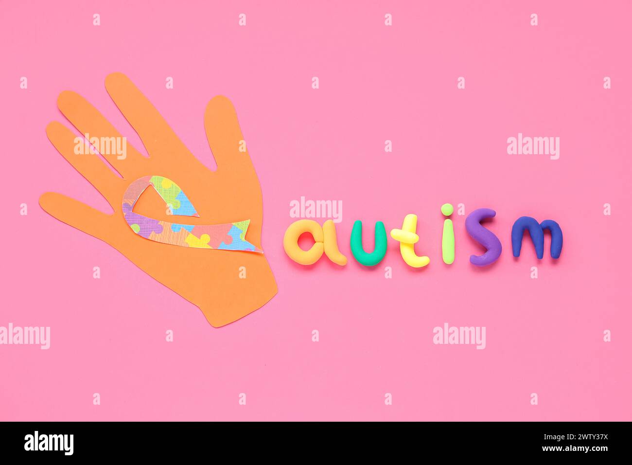 Paper hand and word AUTISM on pink background. Concept of autistic ...