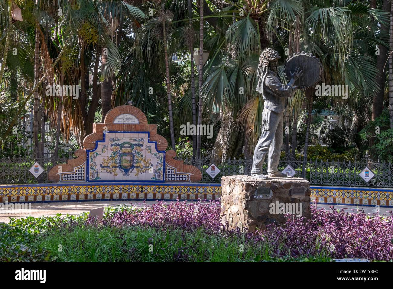 Gardens in the Malaga park and sculpture of the party boy made by ...