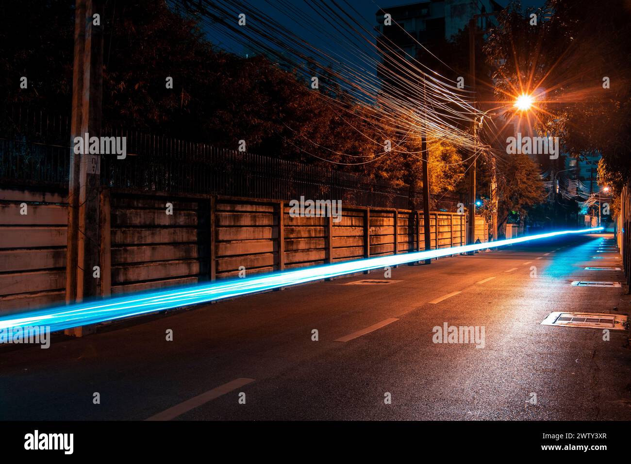 A street at night with a blue line running down the middle Stock Photo ...