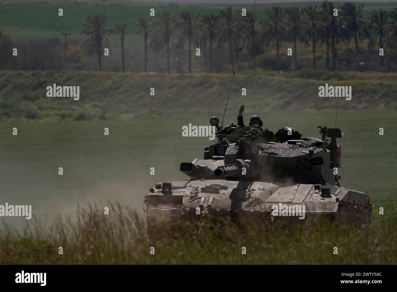 Israeli soldiers move on the top of a tank near the Israeli-Gaza border ...