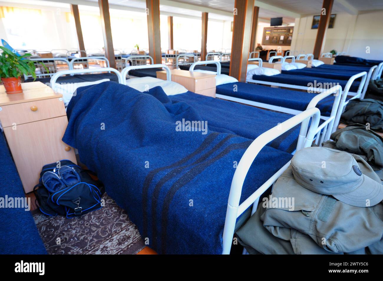 At the room of the barrack: soldier sleeping in his bed, well-made beds ...