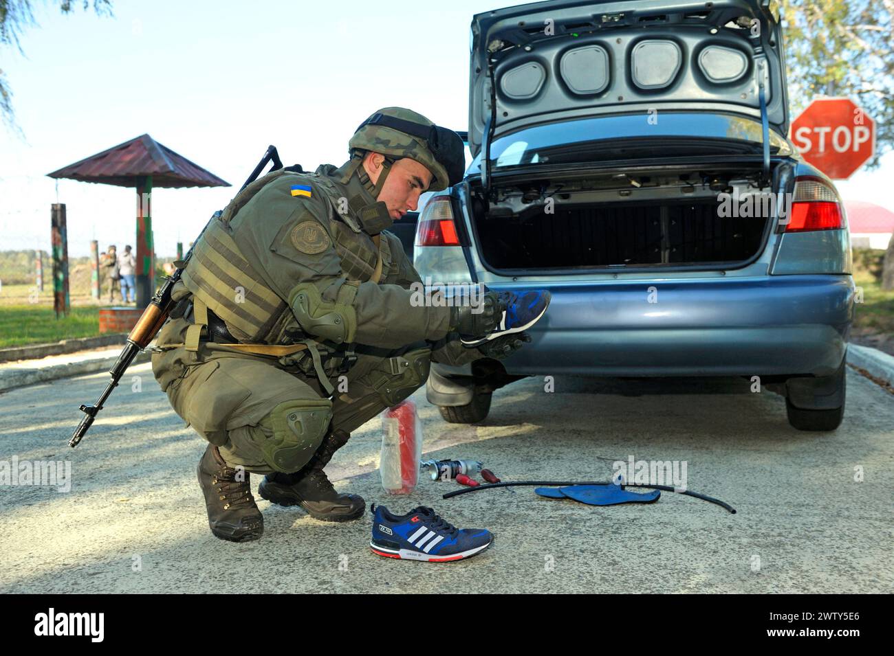 Soldier conducting a search of a stopped car. Checkpoint, training ...