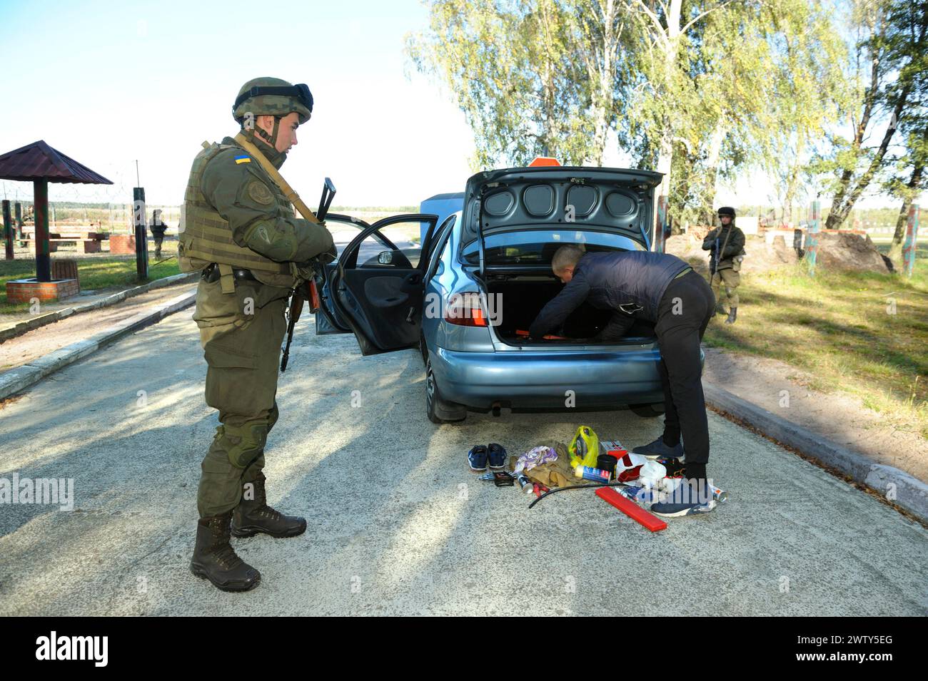 Soldier conducting a search of a stopped car. Checkpoint, training ...