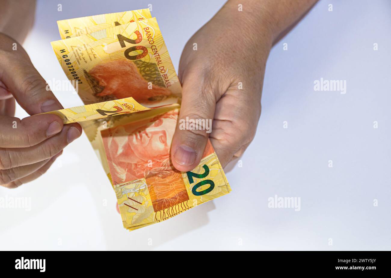 Person displaying a cash money on white background Stock Photo - Alamy