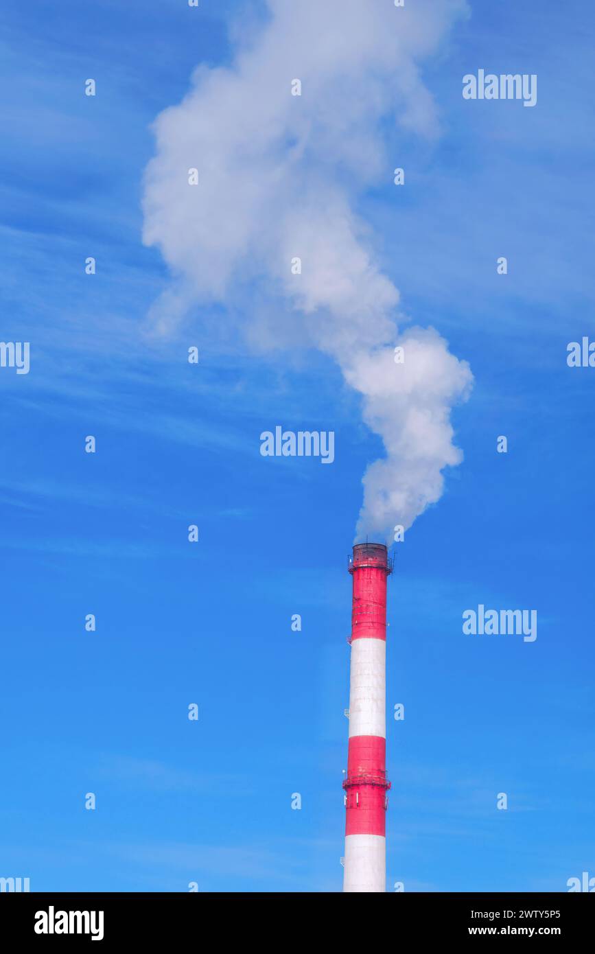 Smoking pipes making clouds against sunset sky background. Dioxide air ...