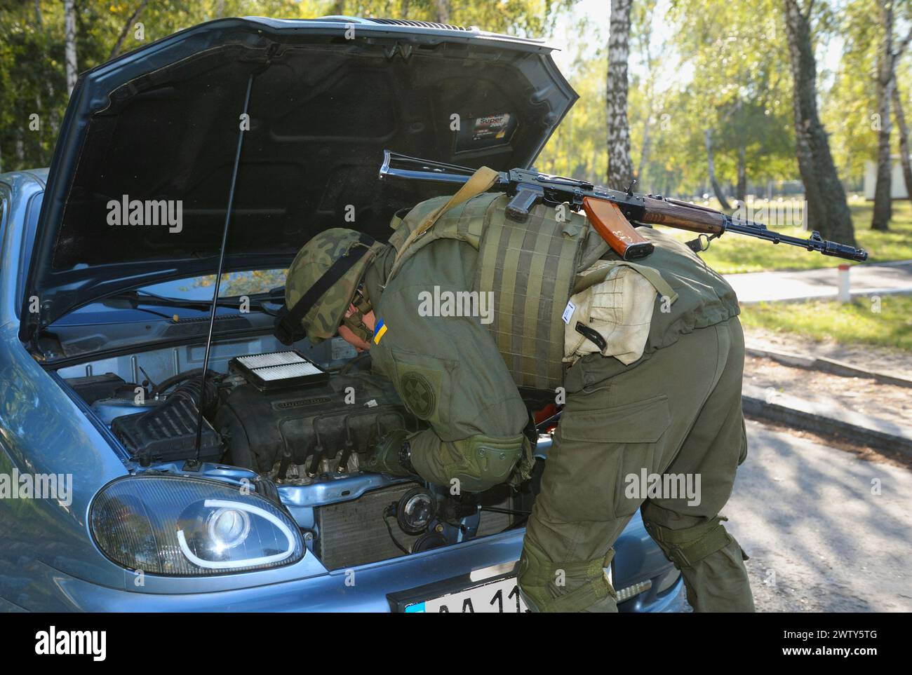 Soldier conducting a search of a stopped car. Checkpoint, training ...