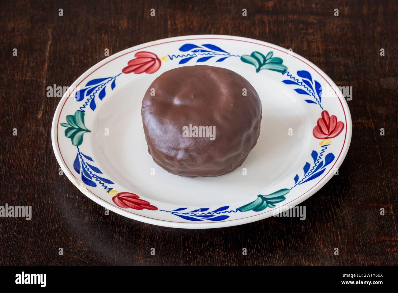 Traditional dutch pastry known as Bossche bol on the plate, chocolate ...