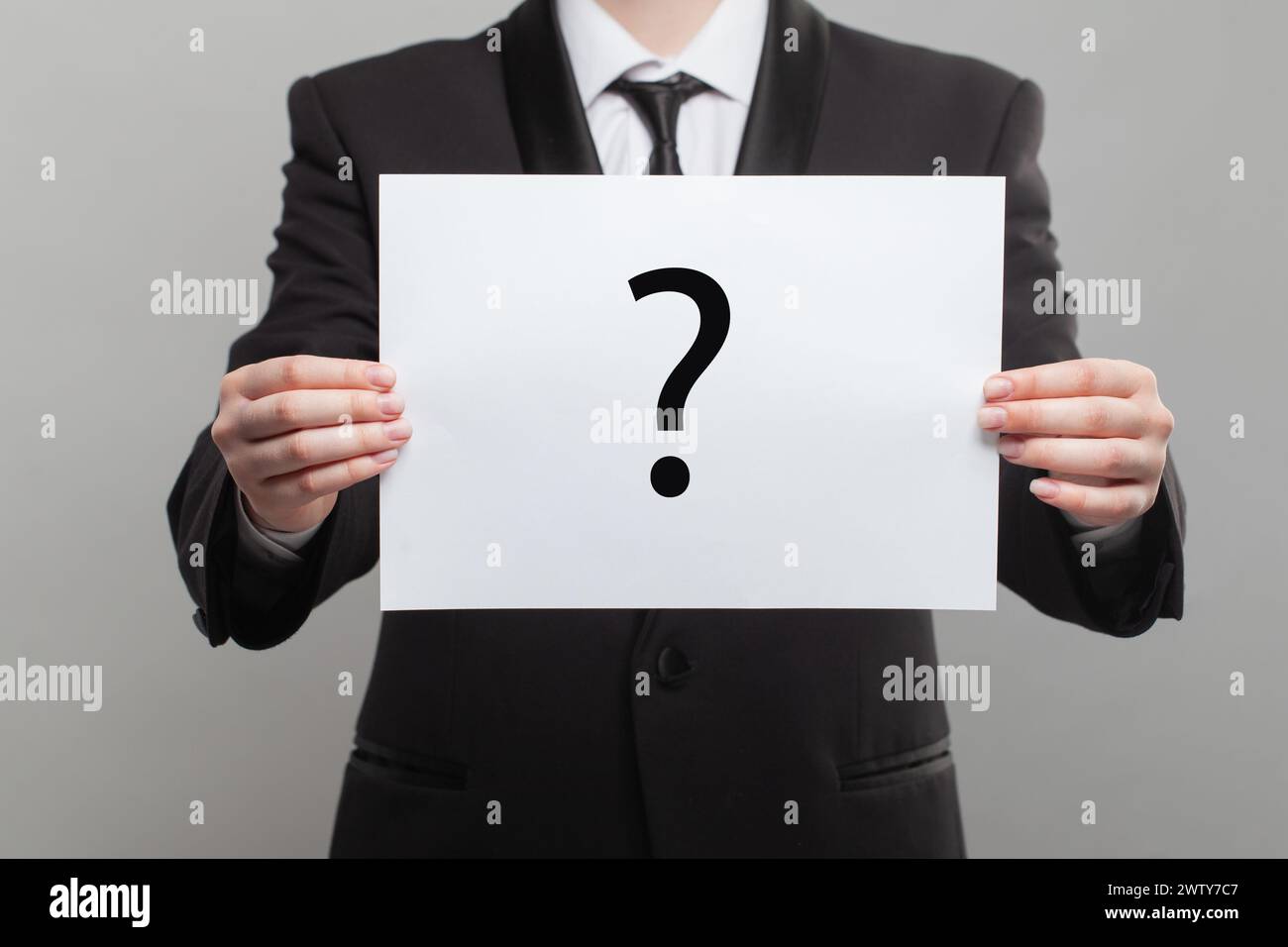 Black question mark on on white paper in hand Stock Photo - Alamy