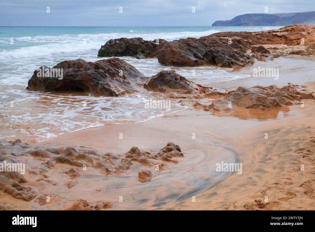 Coastal rocks and shore water. Beach landscape of Porto Santo island on ...