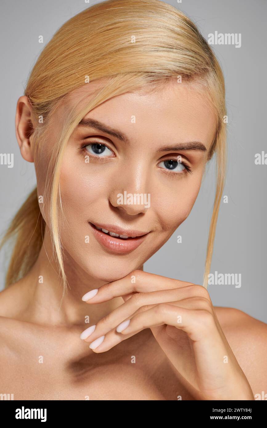 beauty young woman playfully looking forward and touching chin against ...