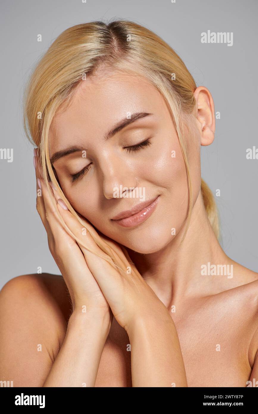 blonde and charming woman in her 20s with calm smile falling asleep ...